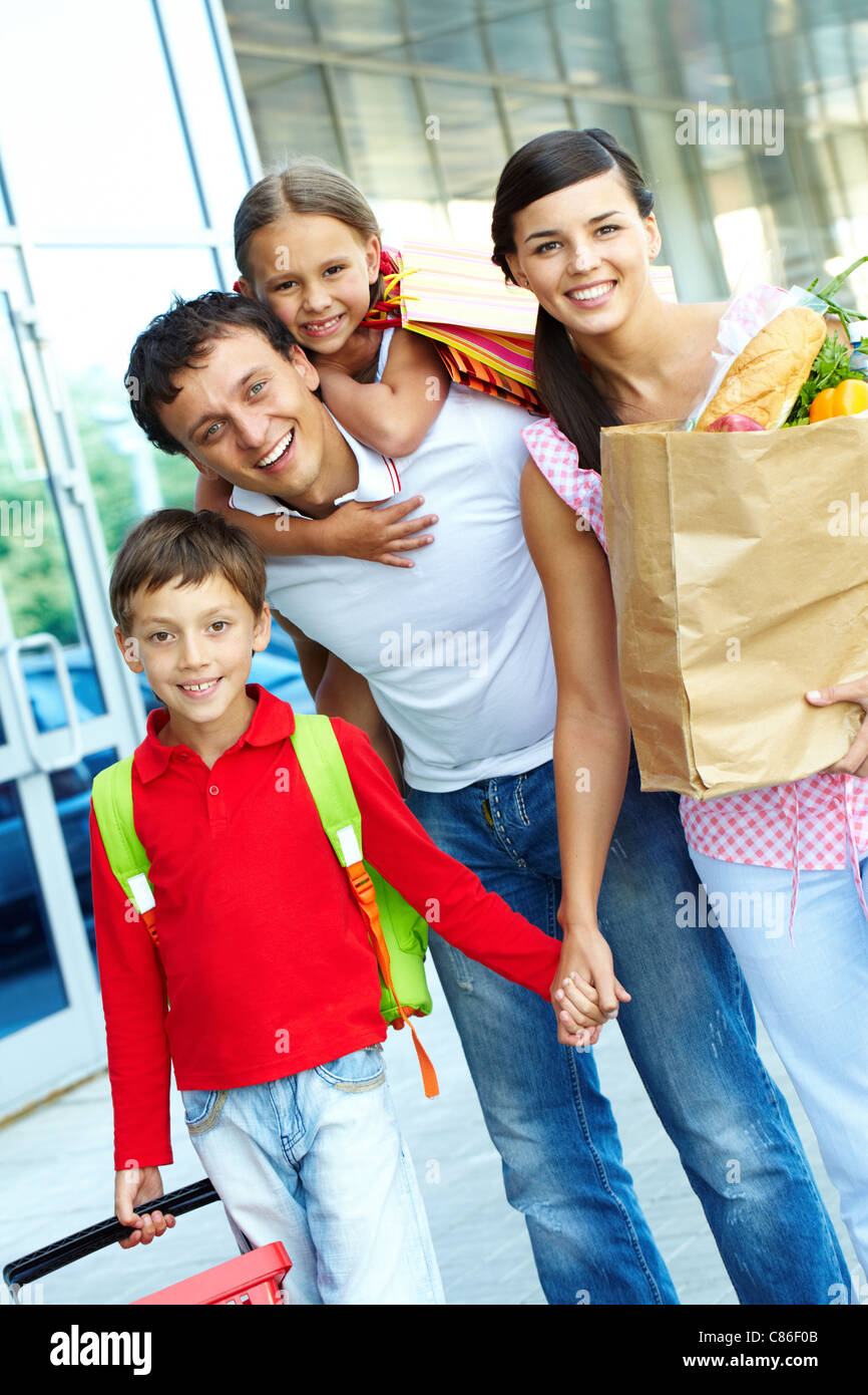 Couple with paperbags and their two children after shopping Stock Photo ...