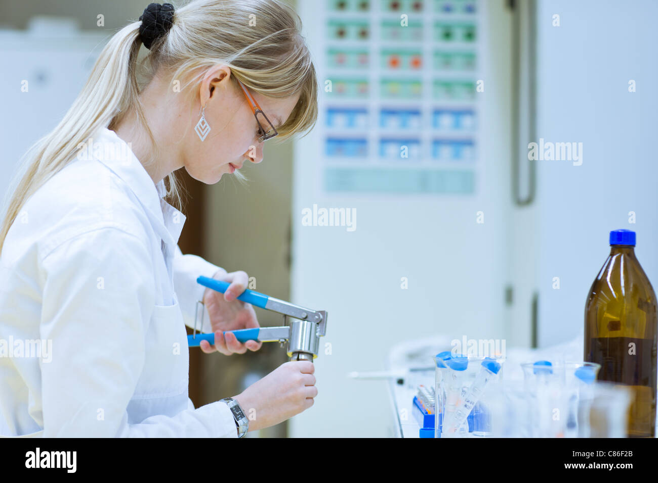 Portrait of a female researcher in a chemistry lab/laboratory (color ...