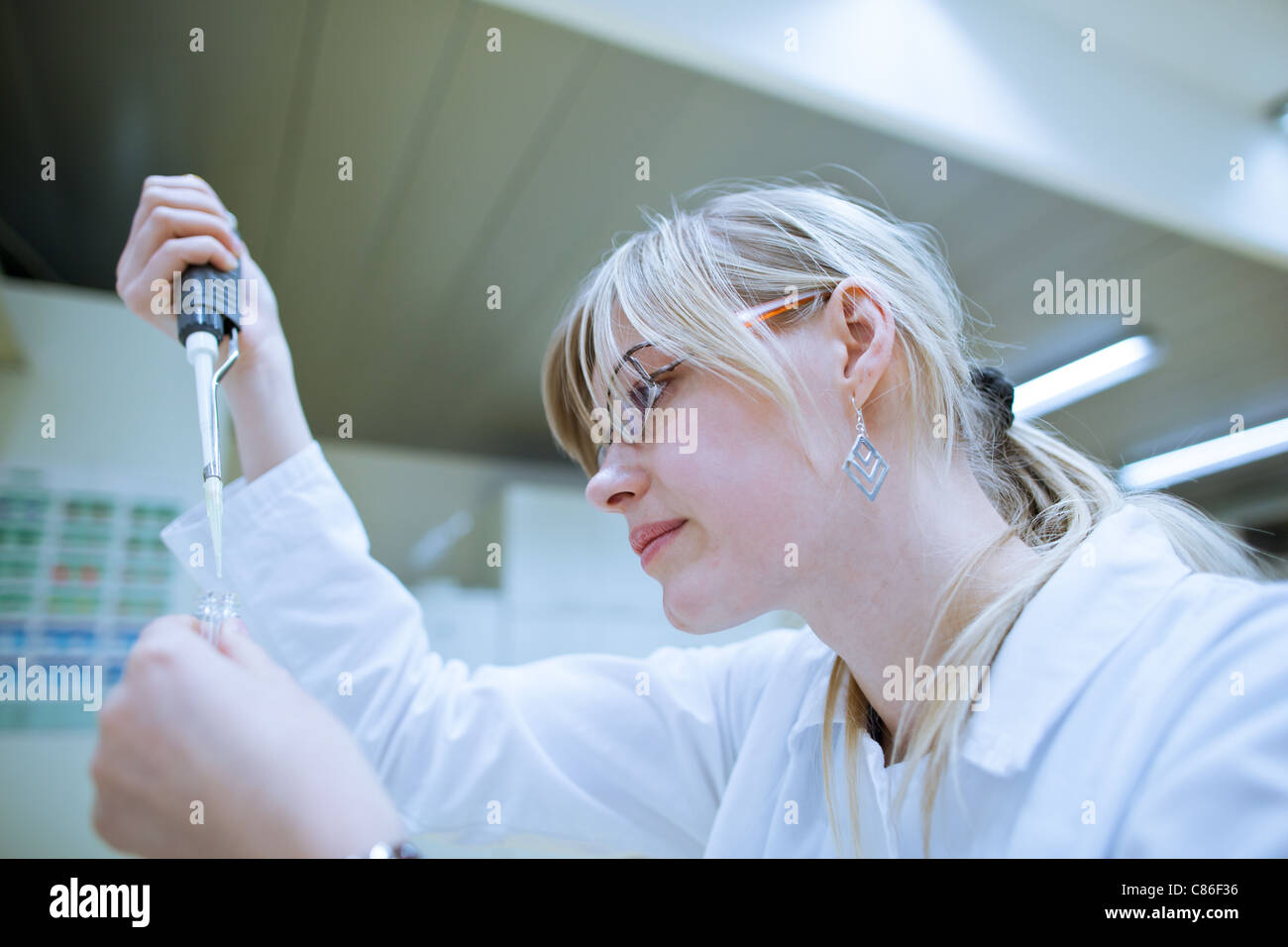 Portrait of a female researcher in a chemistry lab/laboratory (color ...