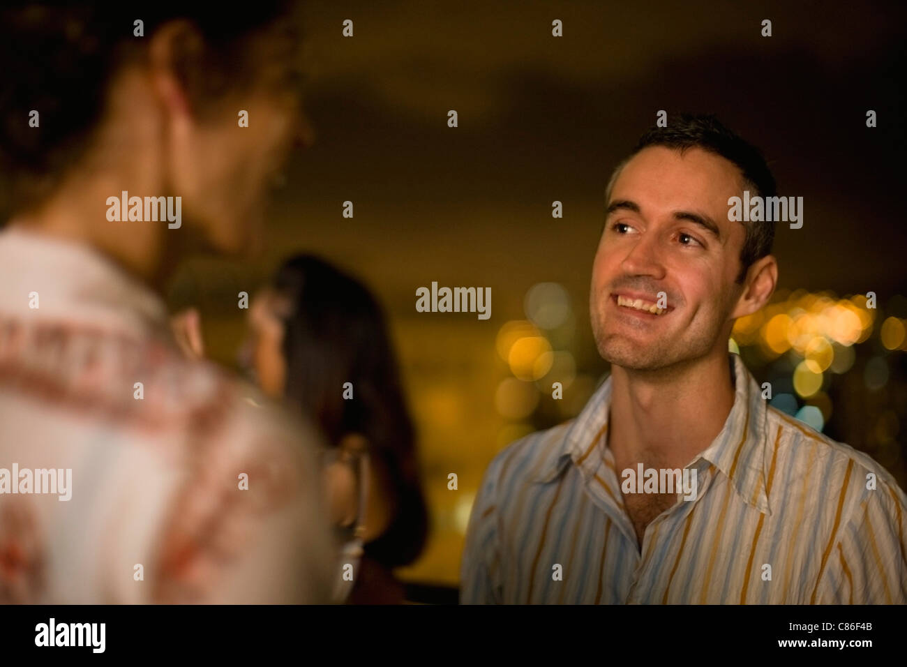 Couple talking outdoors at night Stock Photo - Alamy