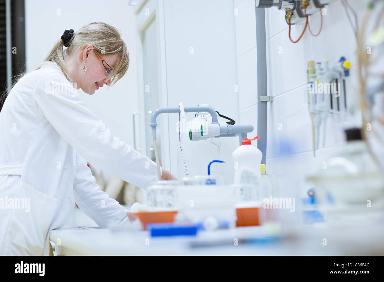 Portrait of a female researcher in a chemistry lab/laboratory (color ...