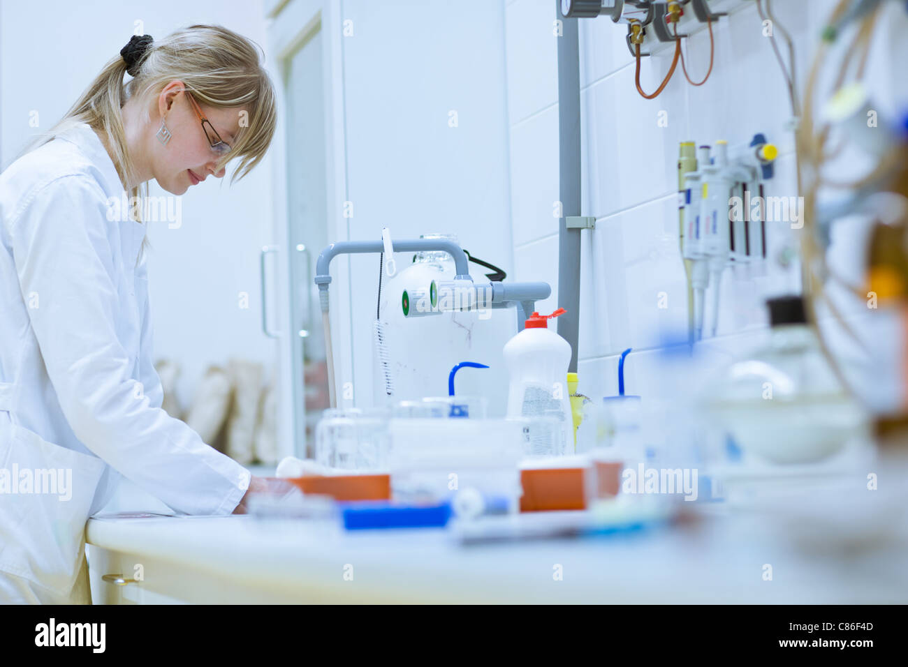 Portrait of a female researcher in a chemistry lab/laboratory (color ...
