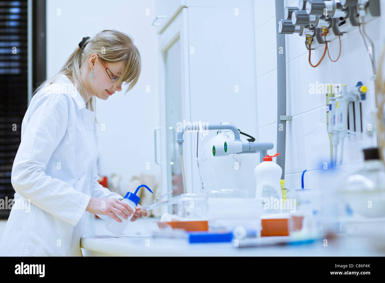 Portrait of a female researcher in a chemistry lab/laboratory (color ...