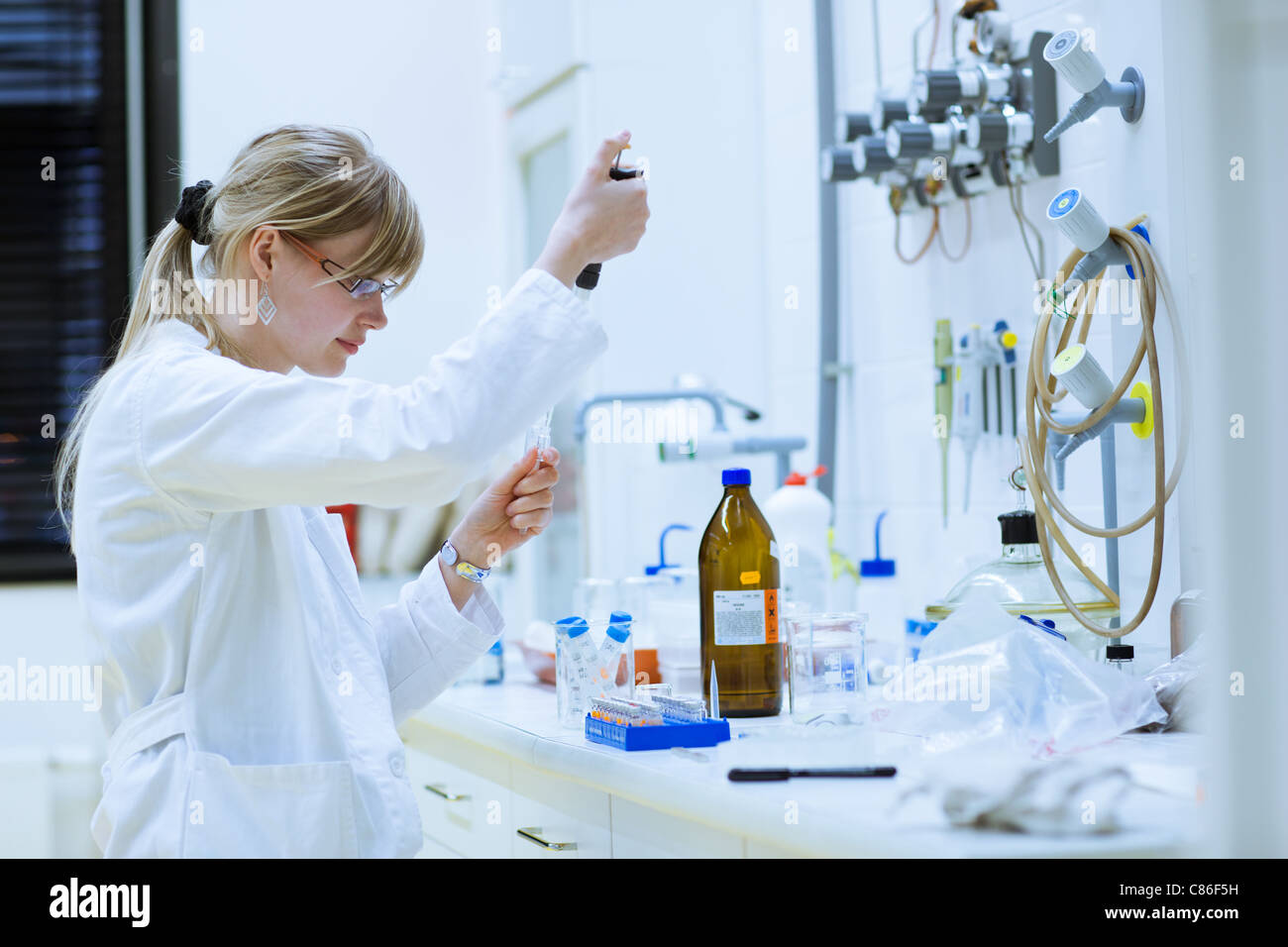 Portrait of a female researcher in a chemistry lab/laboratory (color ...