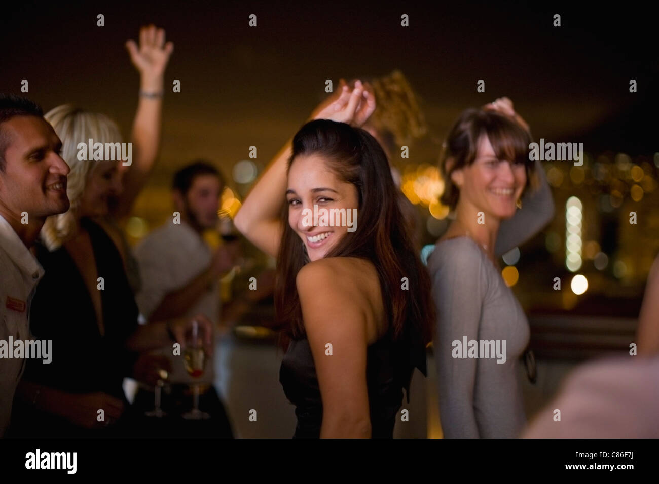 Woman dancing at party at night Stock Photo - Alamy