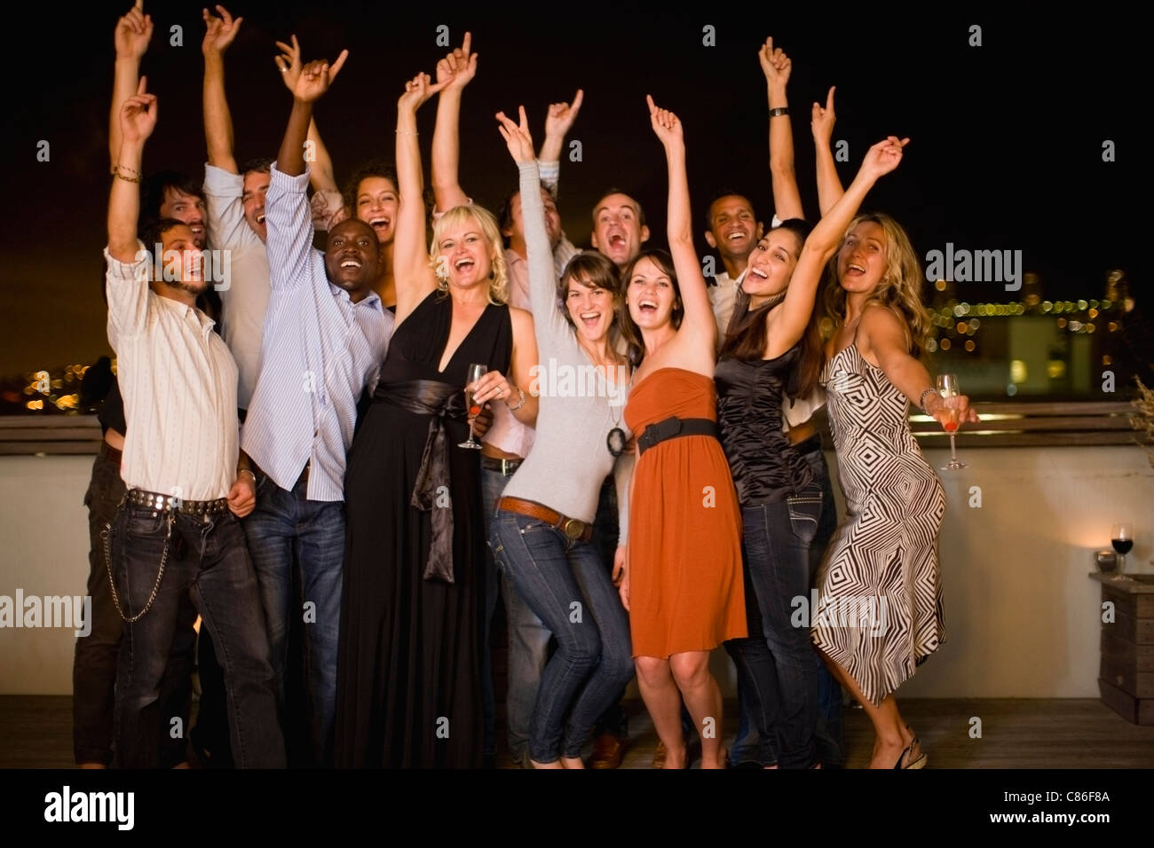 People cheering at party at night Stock Photo - Alamy