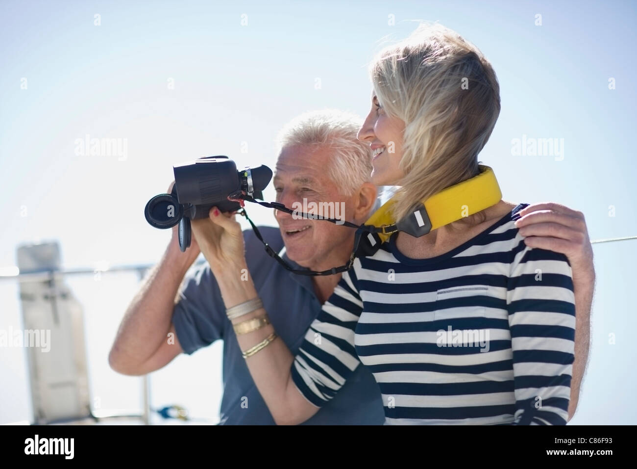 Older couple using binoculars on boat Stock Photo - Alamy