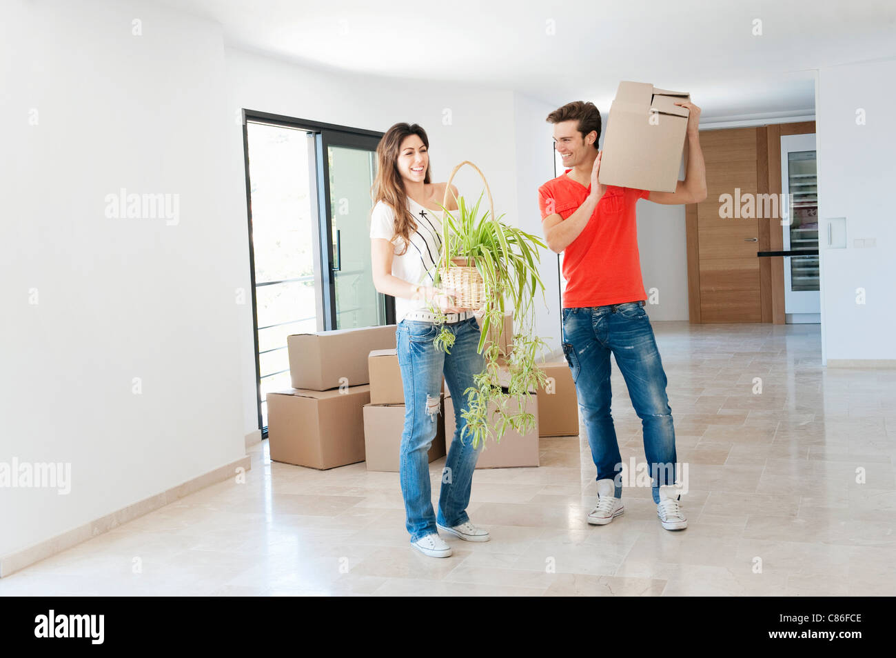 Couple moving into new home Stock Photo - Alamy