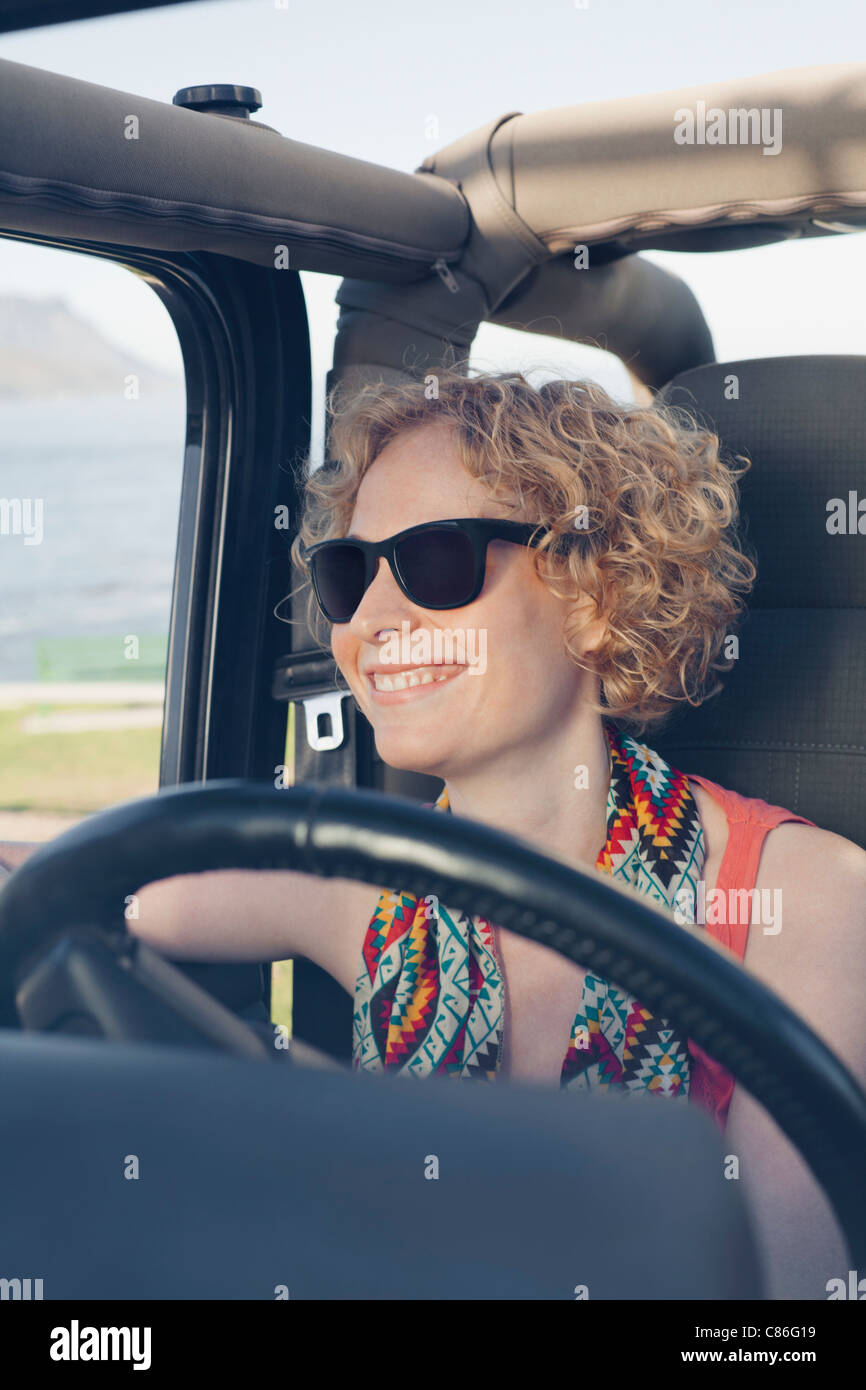 Smiling woman driving jeep Stock Photo - Alamy