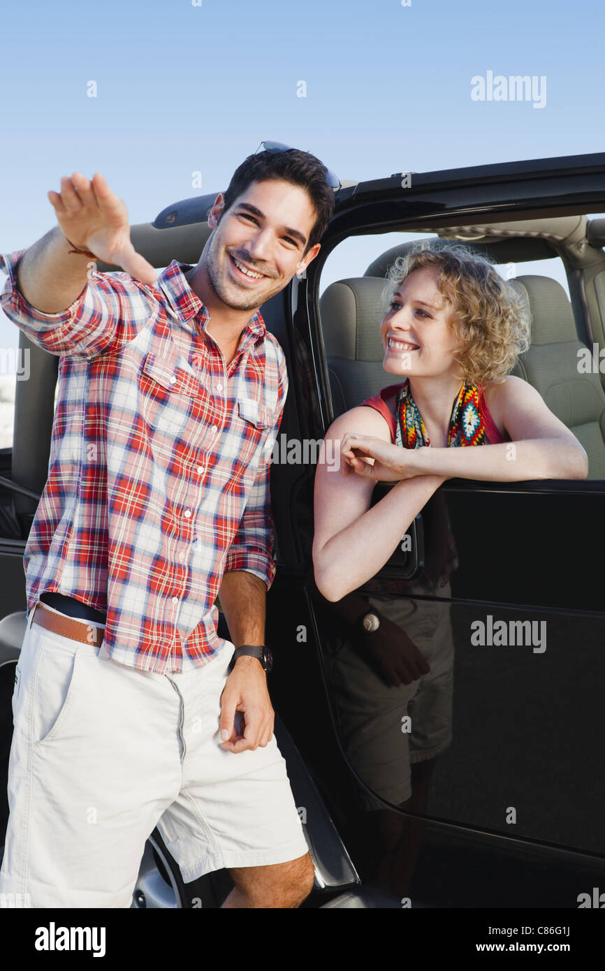 Man giving woman in jeep directions Stock Photo - Alamy
