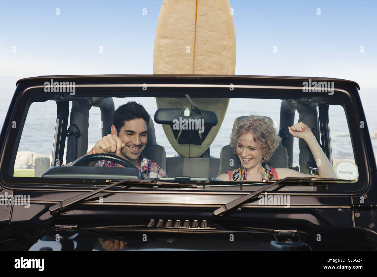Couple riding in jeep together Stock Photo - Alamy