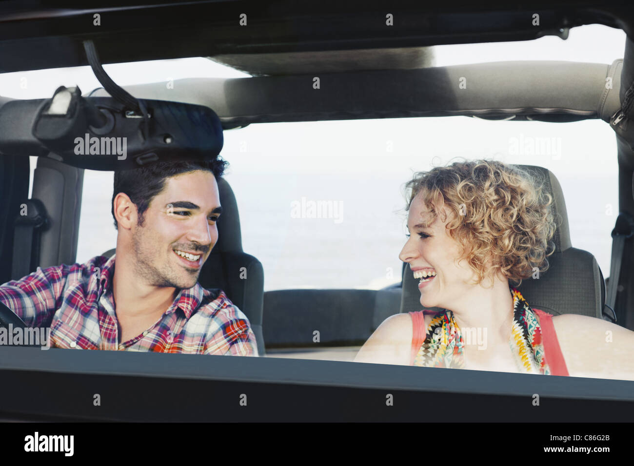 Couple riding in jeep together Stock Photo - Alamy