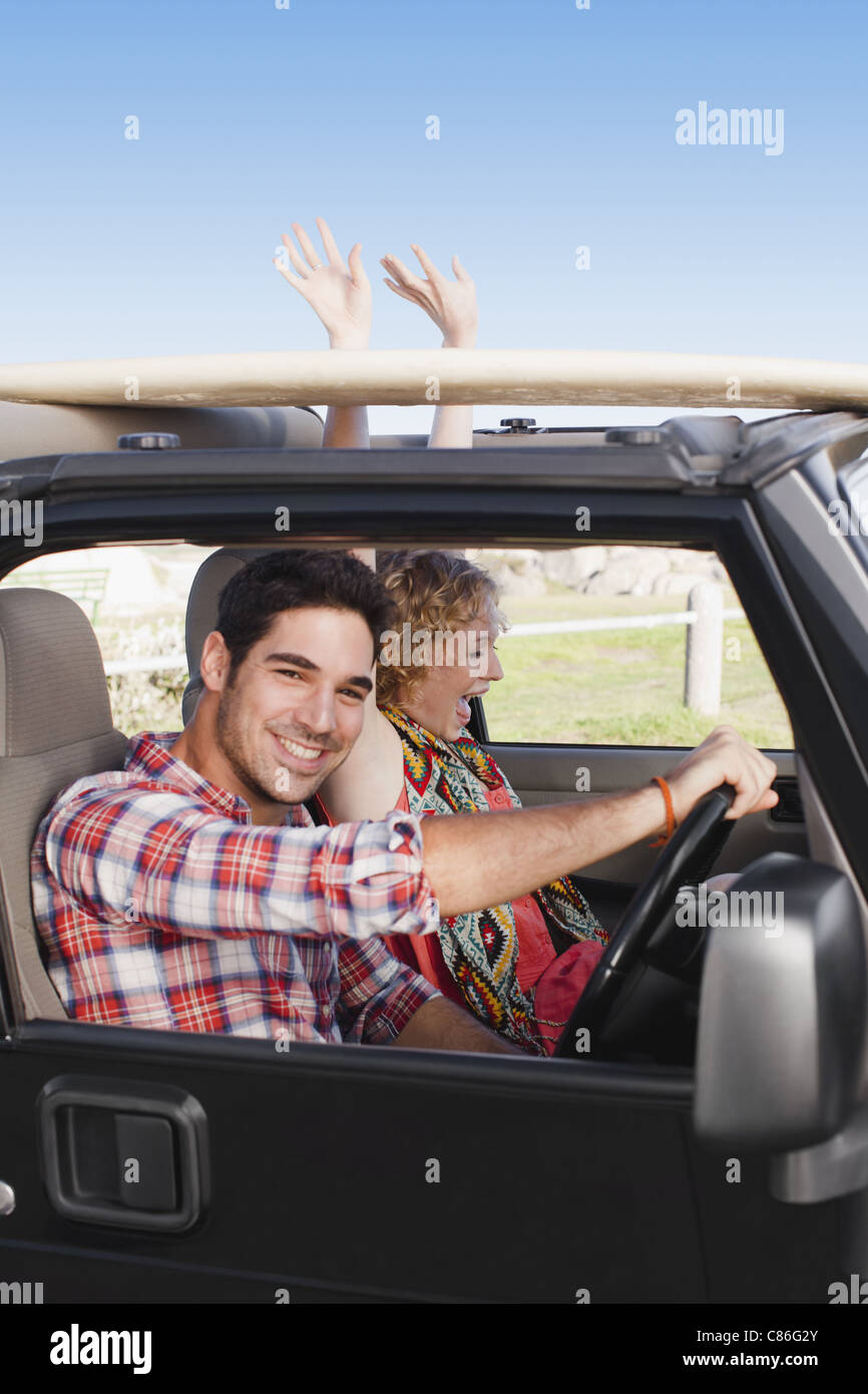 Couple riding in jeep together Stock Photo - Alamy
