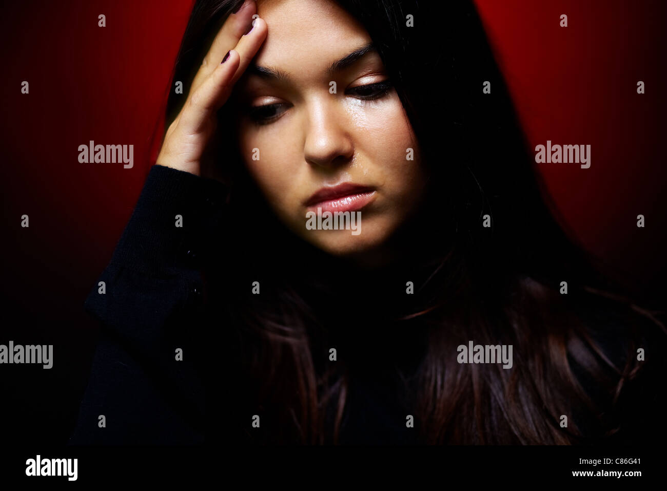 Teenage girl crying in the dark Stock Photo - Alamy
