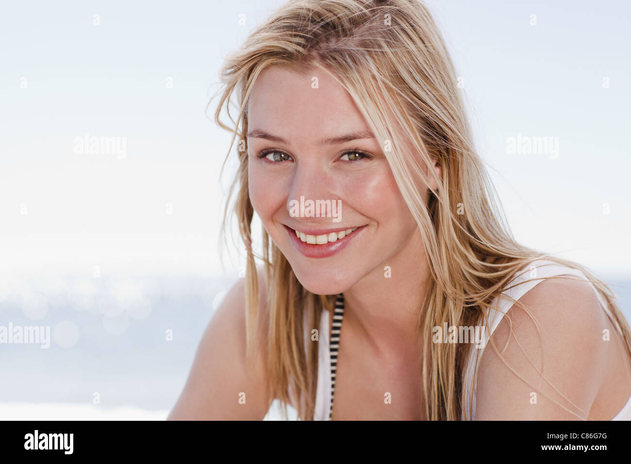 Woman smiling on beach Stock Photo - Alamy