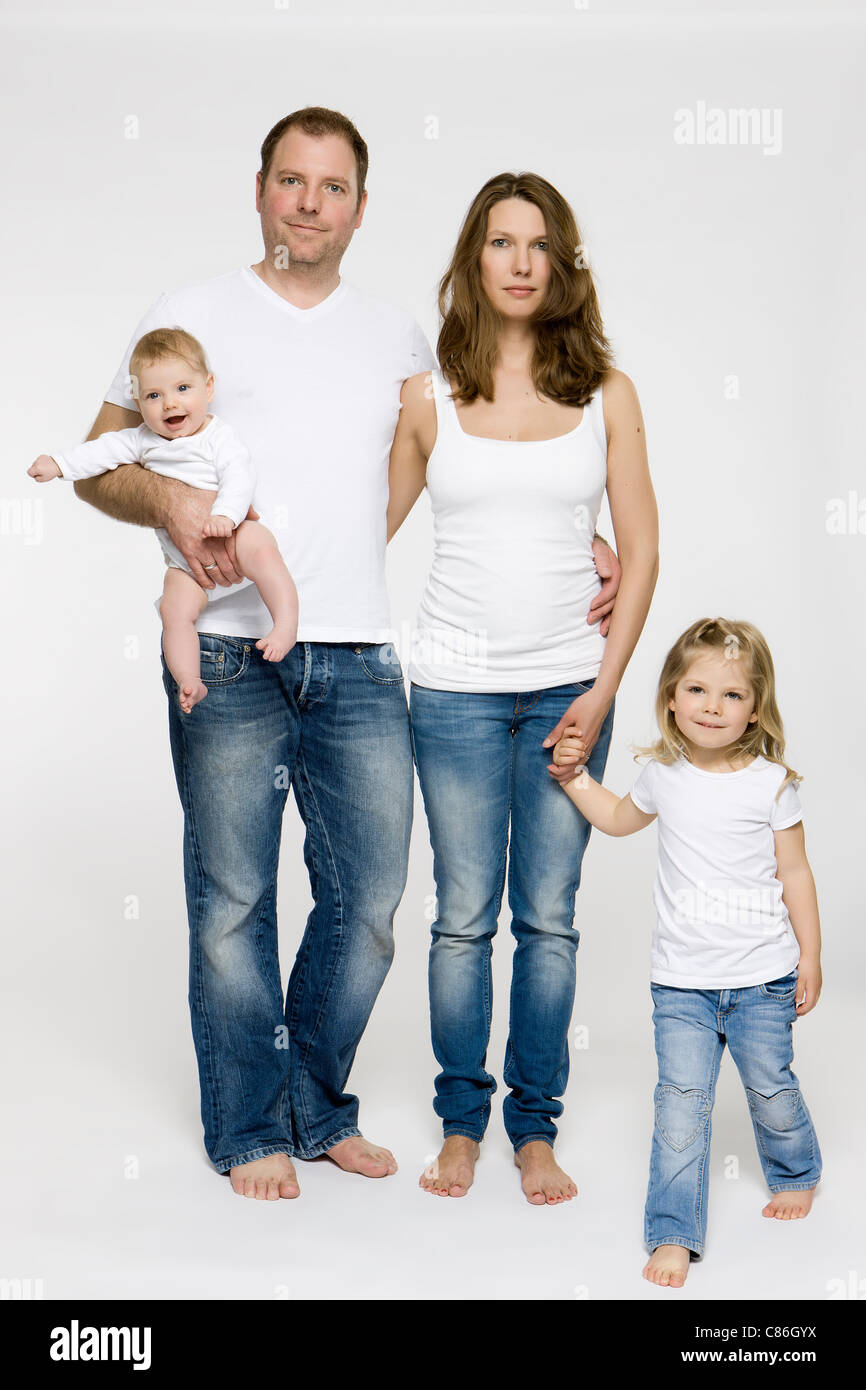 Family standing hand-in-hand Stock Photo - Alamy
