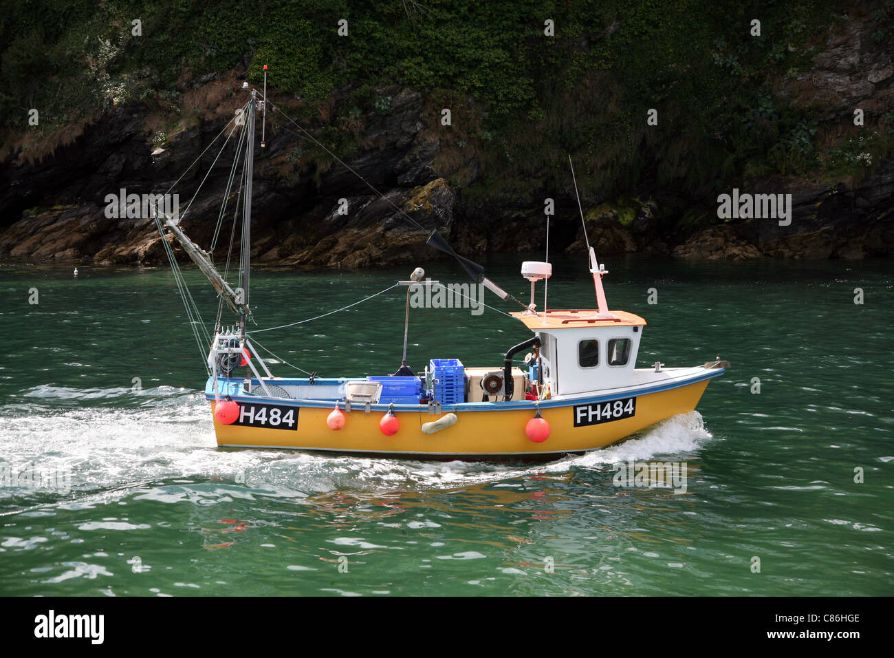 Fishing boat returning to the port of Looe a popular resort of Looe on ...