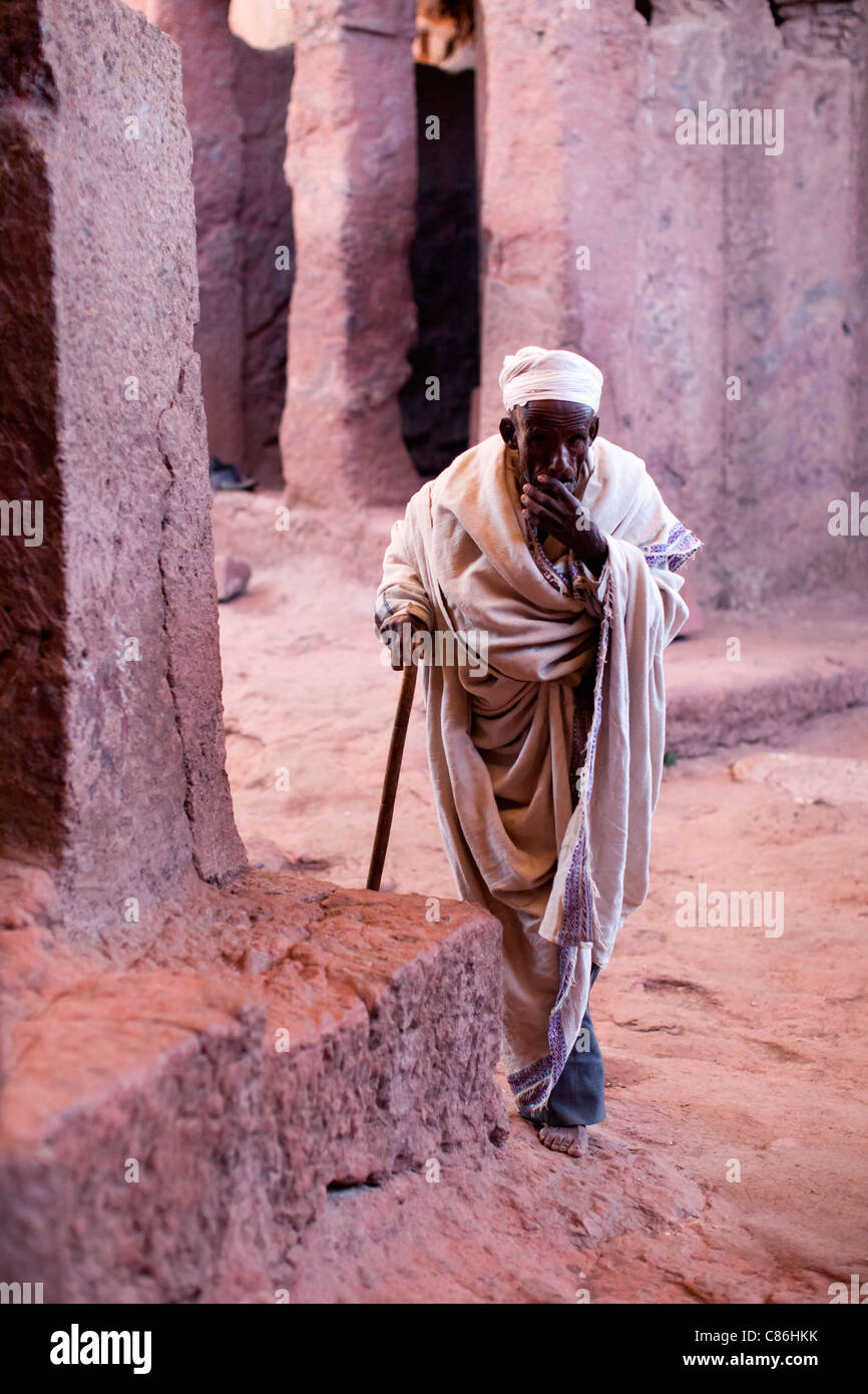 An Orthodox Christian pilgrim in a courtyard between the rock-hewn ...