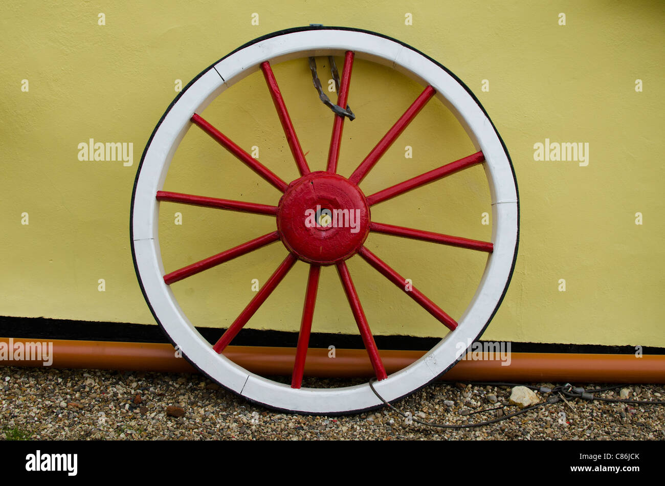 Round wheel against a wall Stock Photo - Alamy