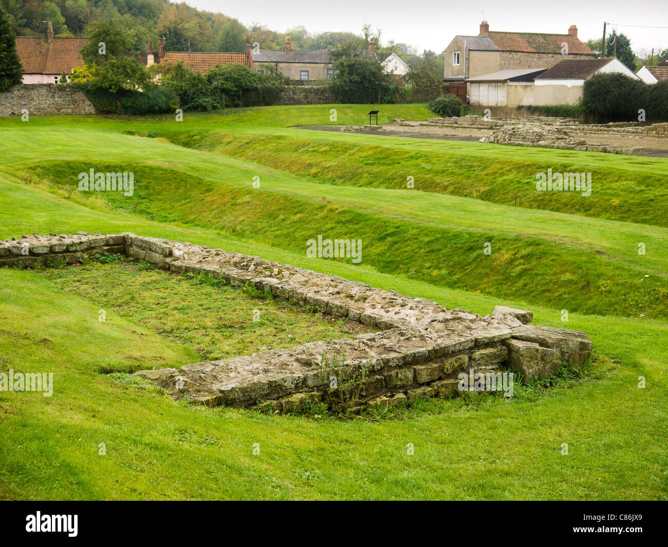 Man trap hollows in the remains of the Roman Fort behind the houses in ...