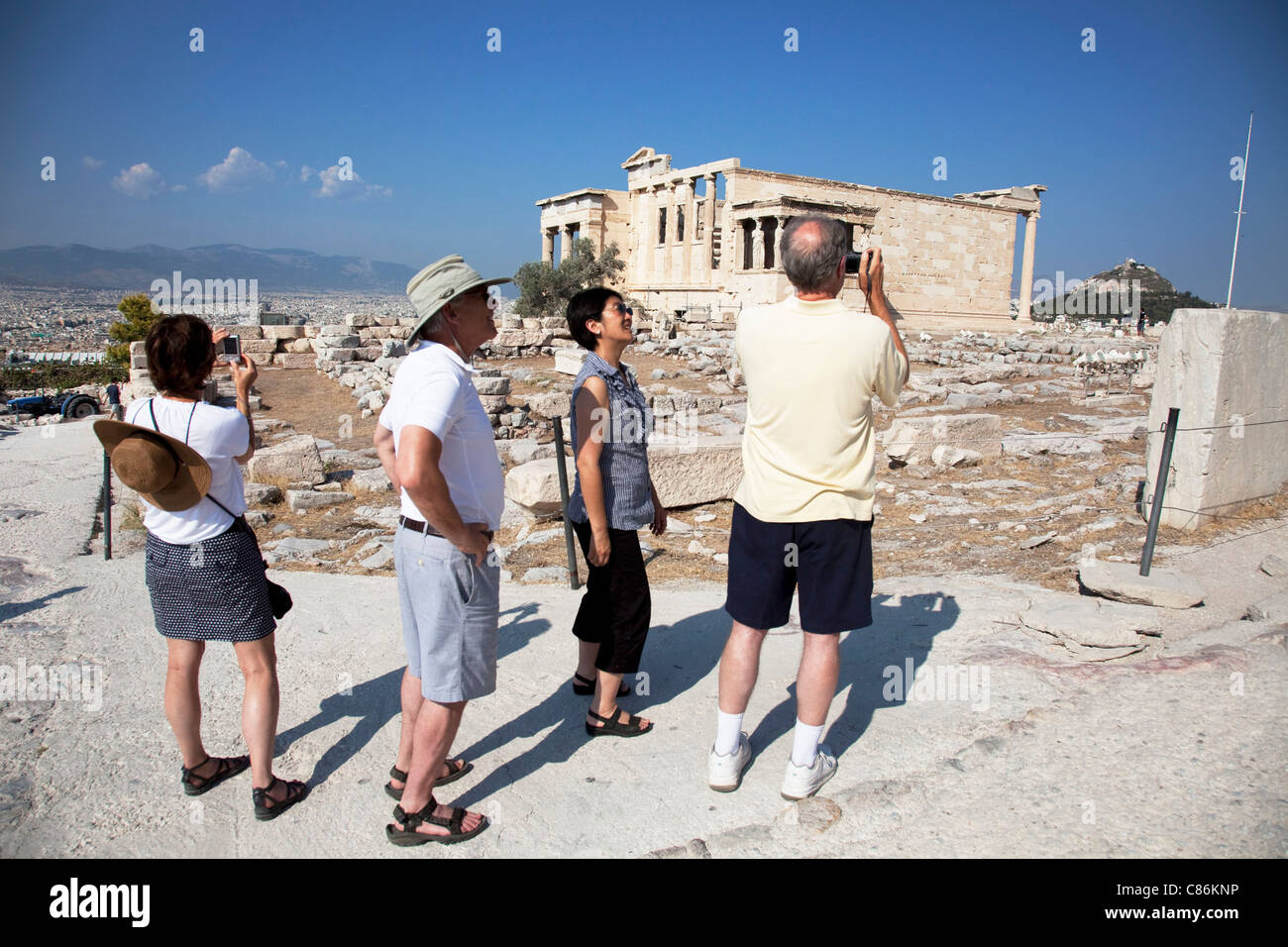 Tourists and visitors at the ancient Greek temples at Acropolis of ...