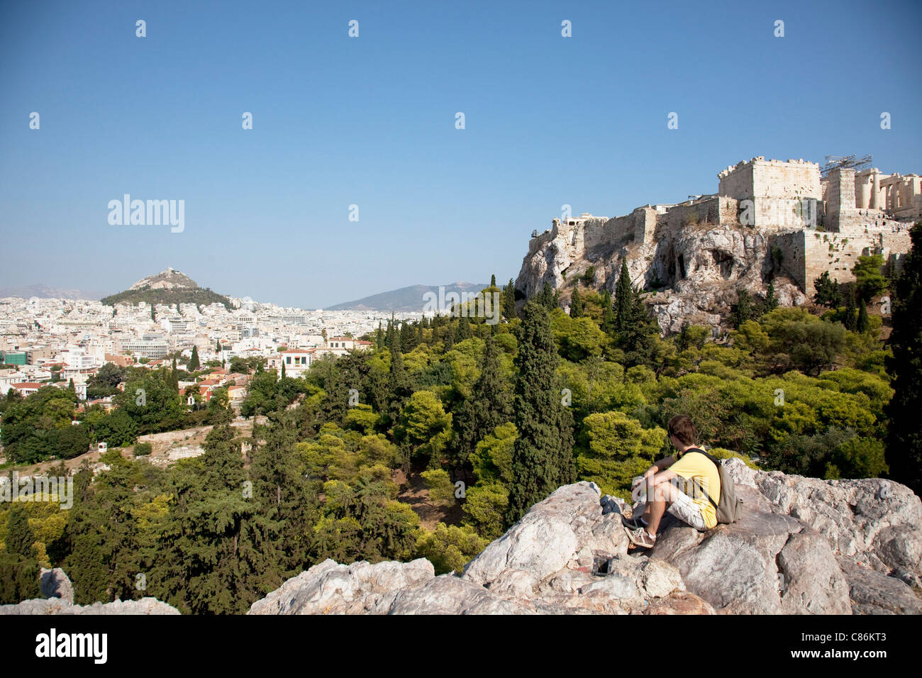 Tourists enjoy the view from The Areopagus or Areios Pagos is the 'Rock ...