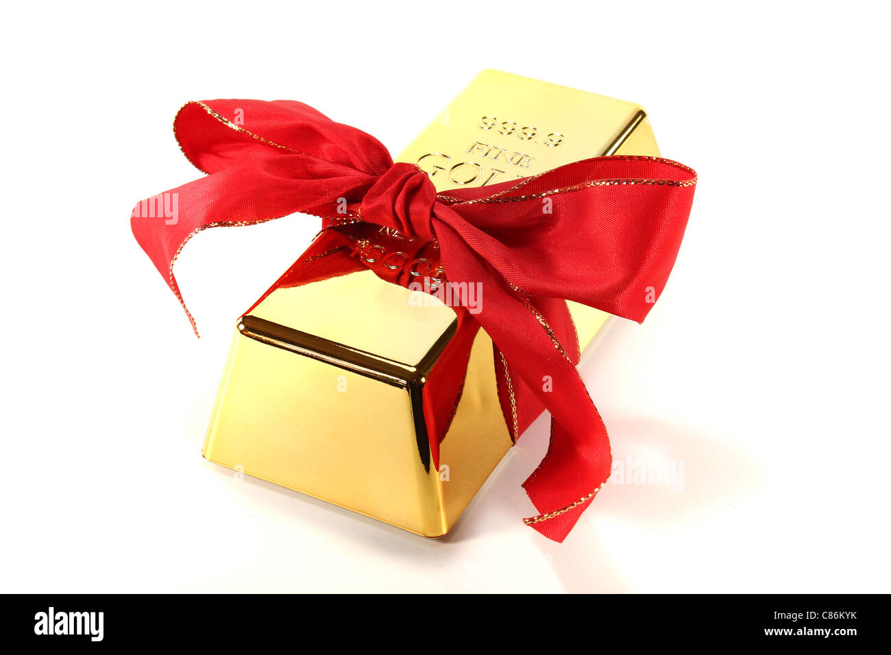 Gold bars with red bow on a white background Stock Photo - Alamy