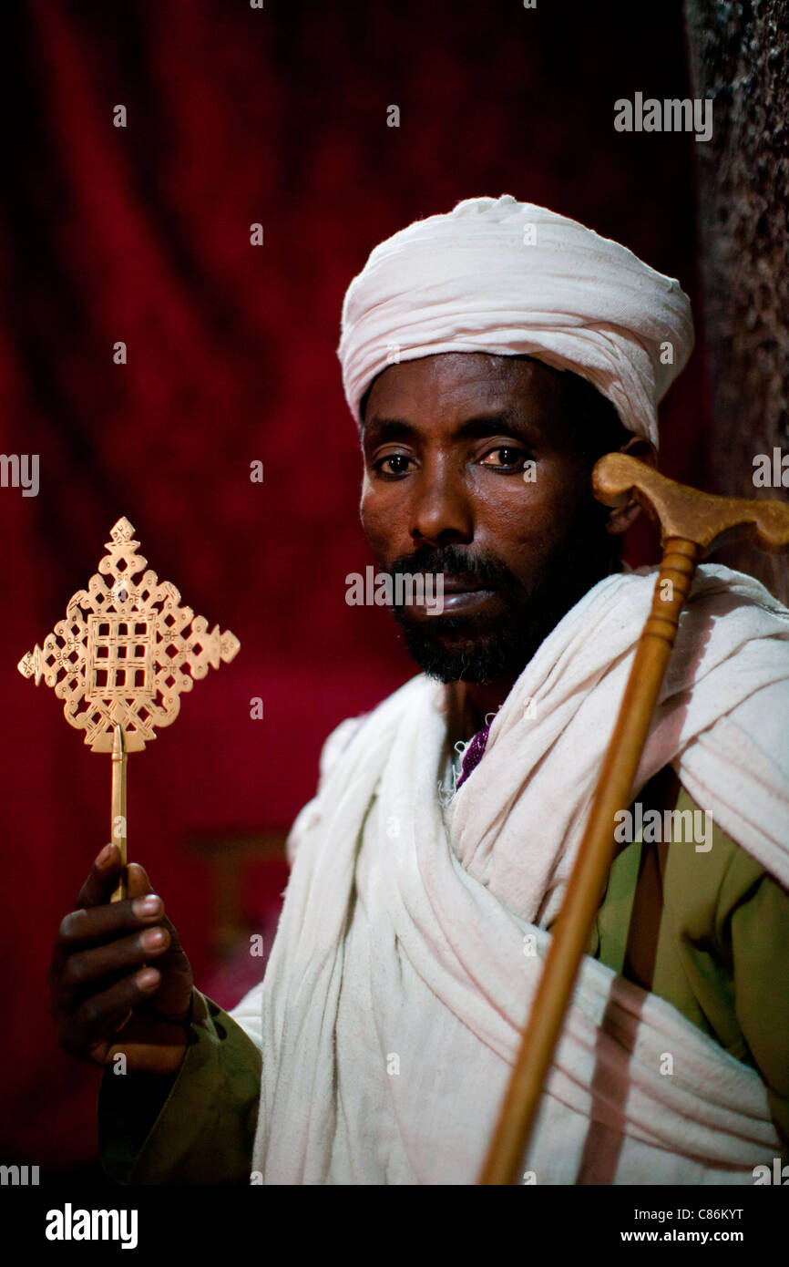 An Orthodox Christian priest with cross and staff at the rock-hewn ...