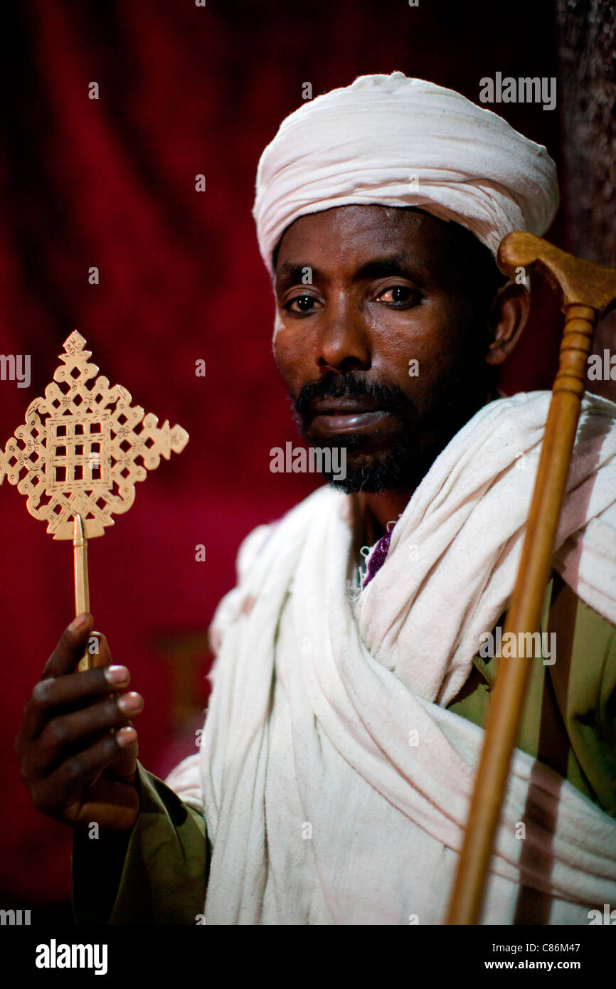 An Orthodox Christian priest with cross and staff at the rock-hewn ...