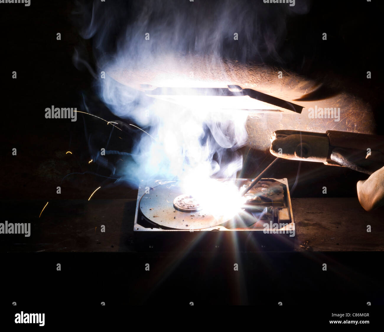 welding scenery with hard disk drive, welding mask detail and flashy ...