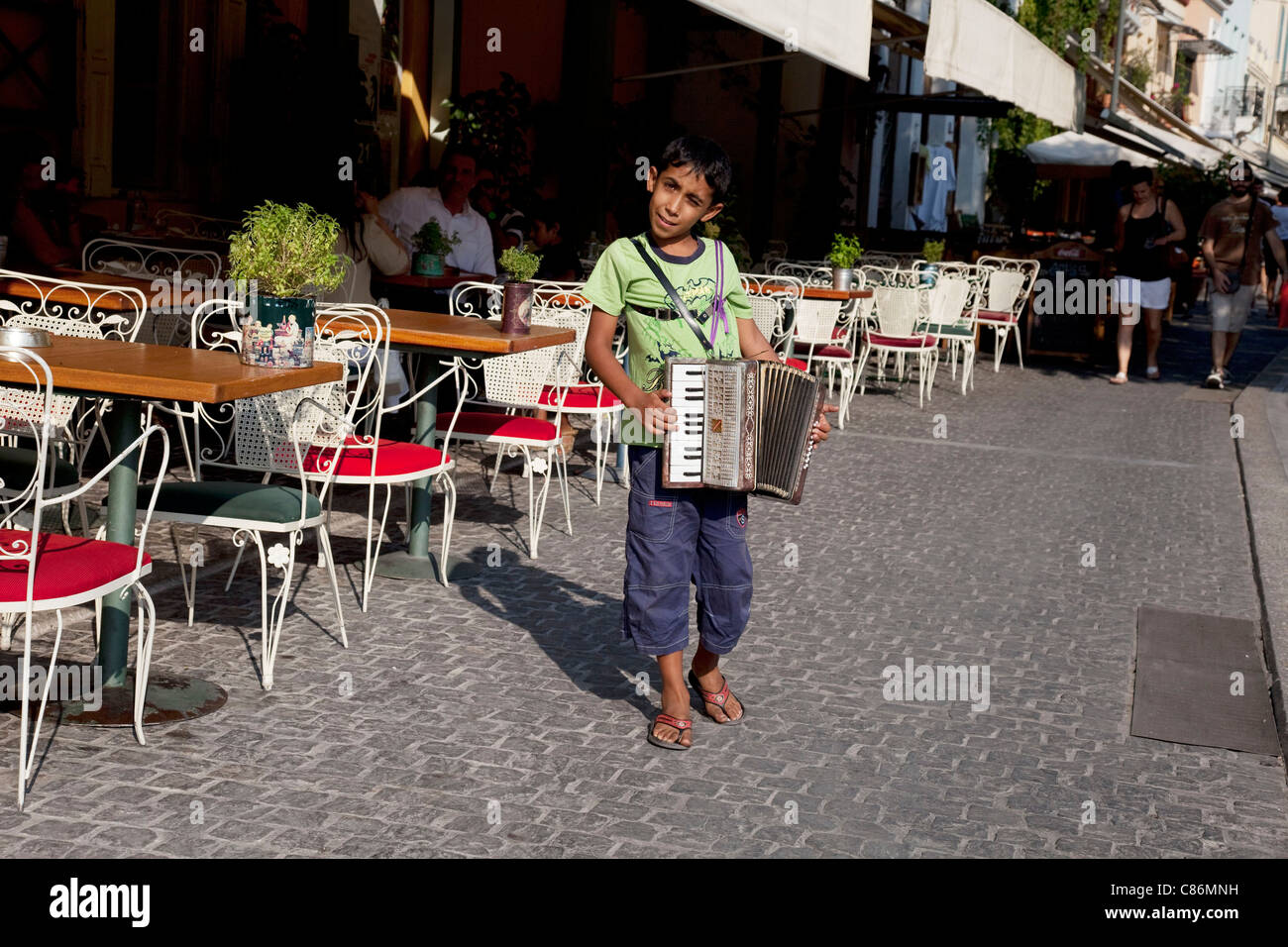 Young boy busking with his accordion in Monastiraki. Athens, Greece ...