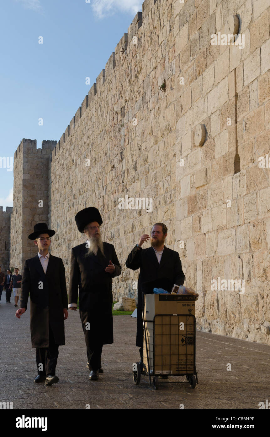 Orthodox Jews walking along the city walls. Jaffa Gate. Jerusalem Old ...