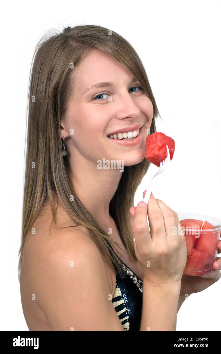 Girl against plain white background eating Stock Photo - Alamy