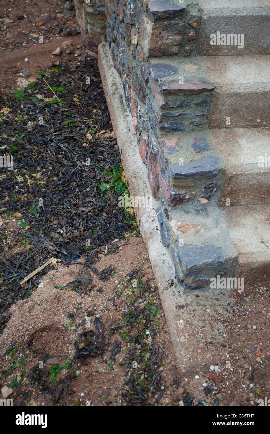Edge detail on stone clad concrete steps on a beach Stock Photo - Alamy