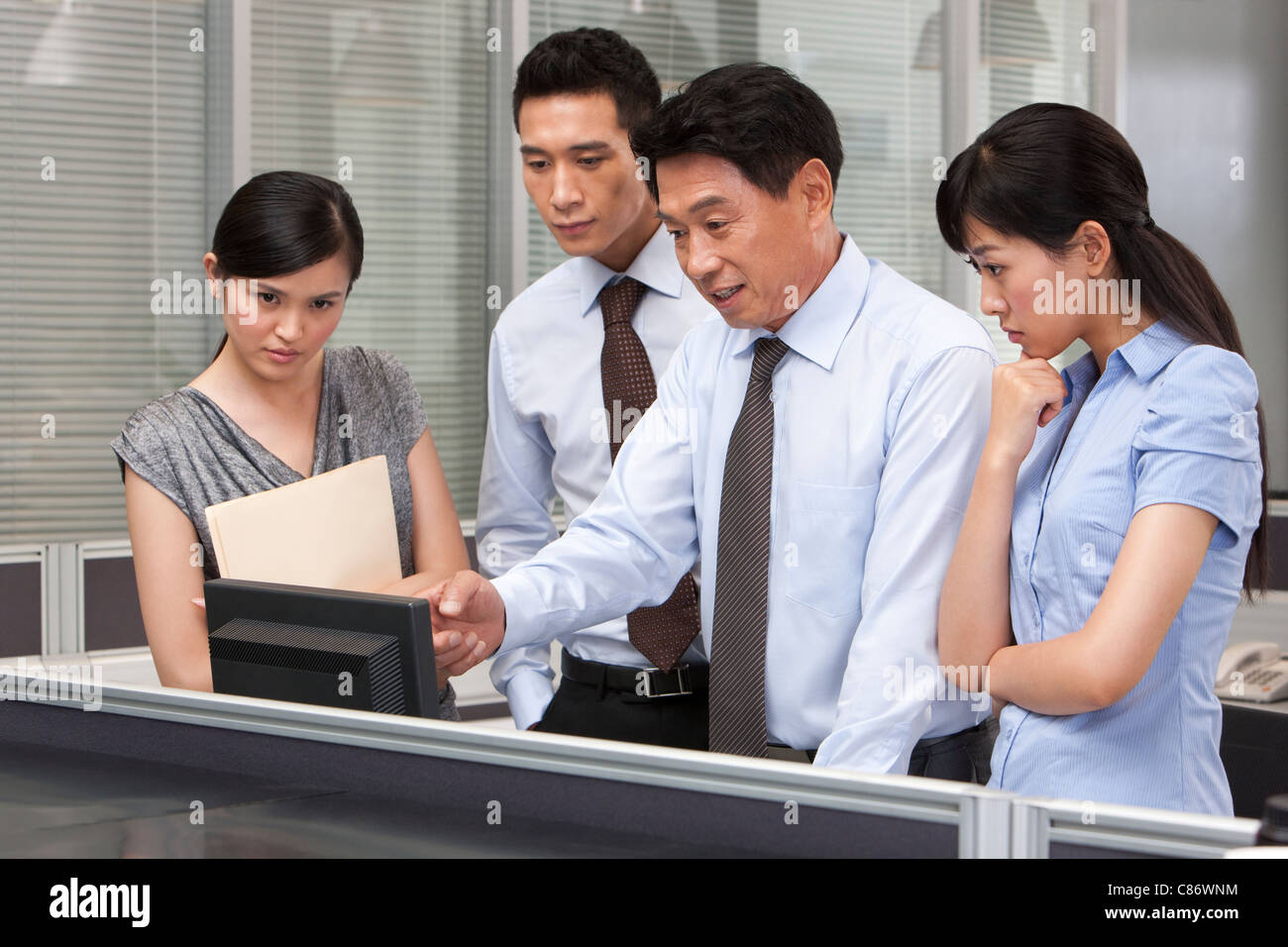 Senior Colleague Helping Co-workers Stock Photo - Alamy