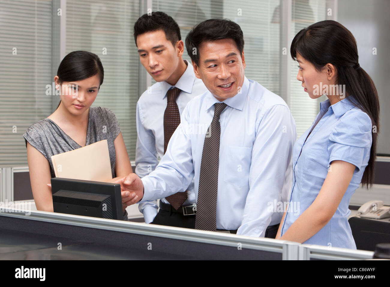 Senior Colleague Helping Co-workers Stock Photo - Alamy