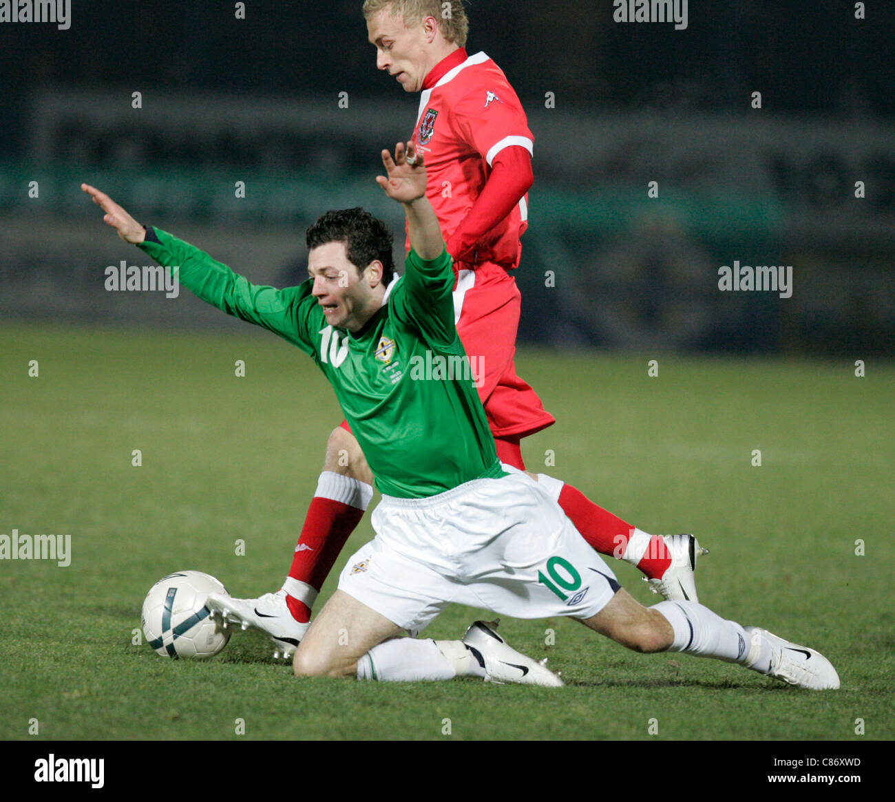 Northern Irelands Ivan Sproule goes to ground after a challenge from ...