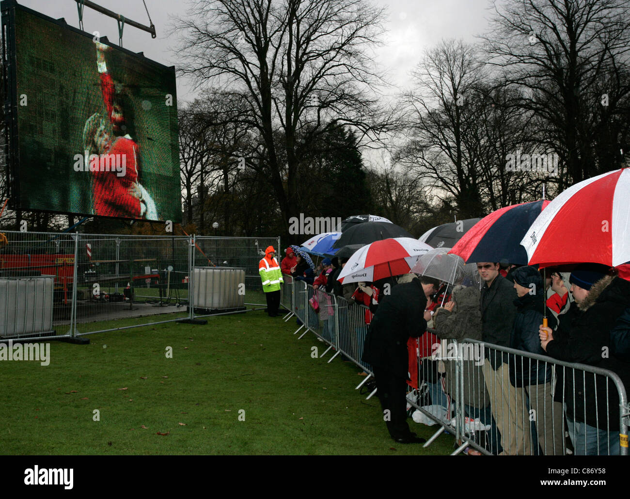 Fans watch tributes on the big screen at George Best's Funeral ...