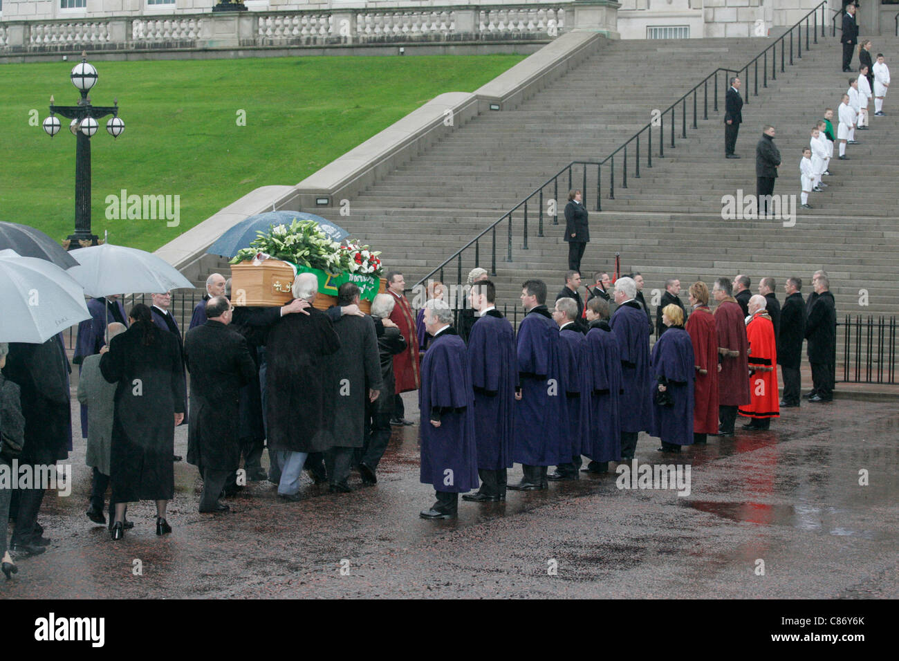 George Bests coffin is carried towards the steps of Parliament ...