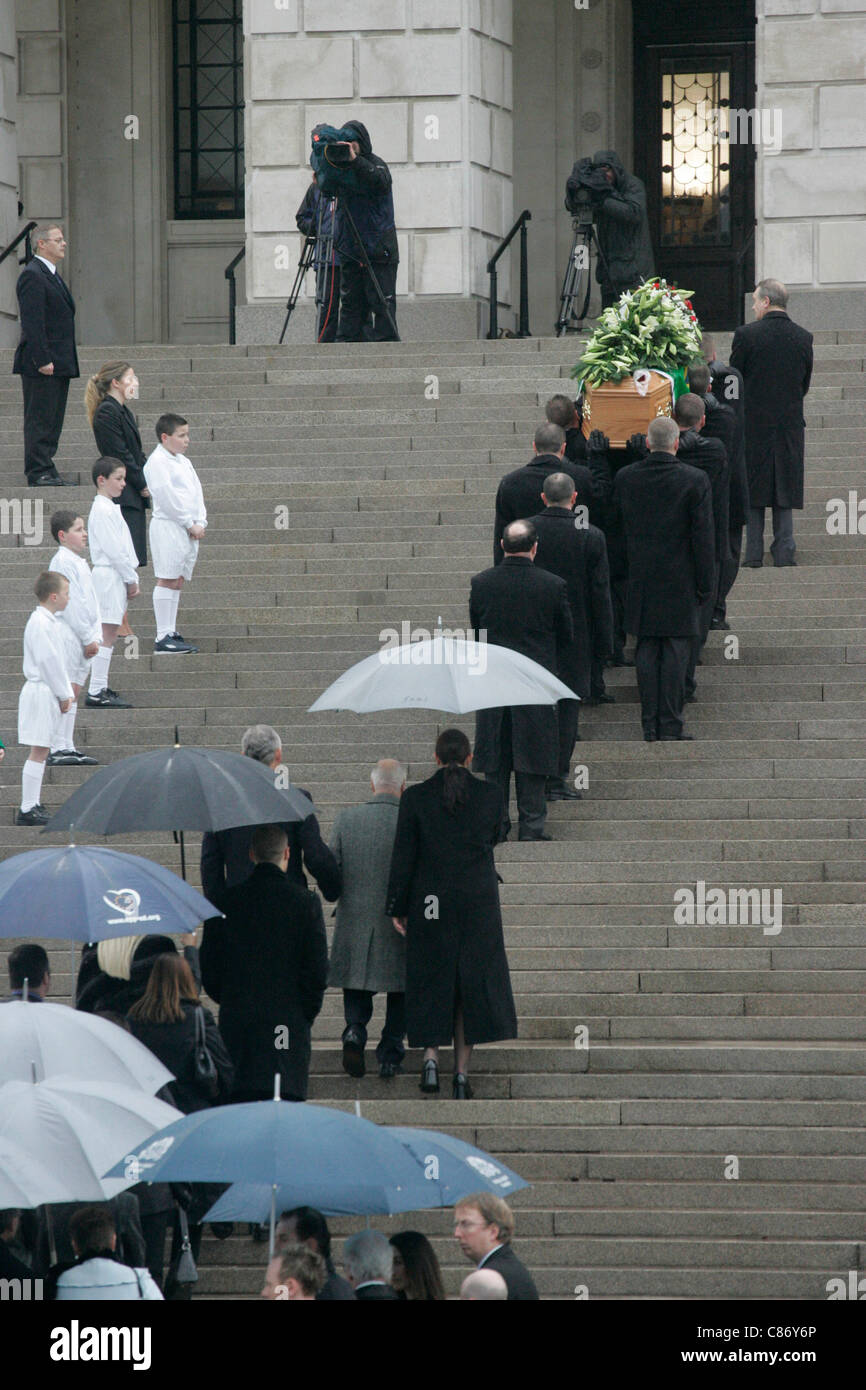 George Bests coffin is carried up the steps of Parliament Buildings ...