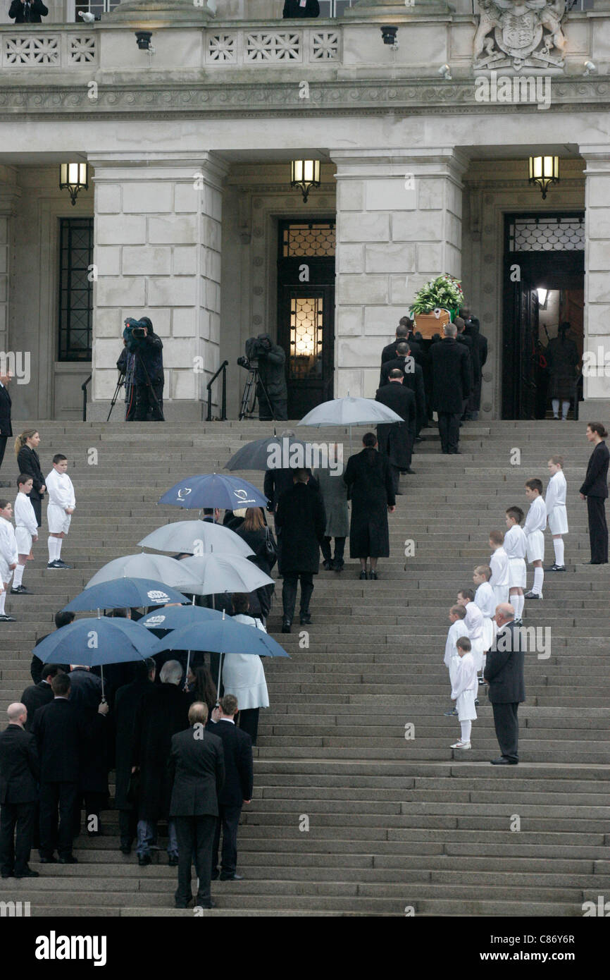 George Bests coffin is carried up the steps of Parliament Buildings ...