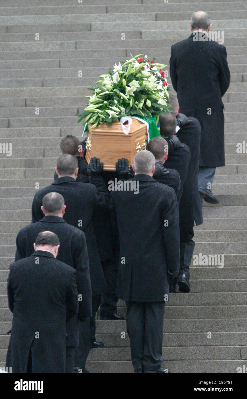 George Bests coffin is carried up the steps at Parliament Buildings ...