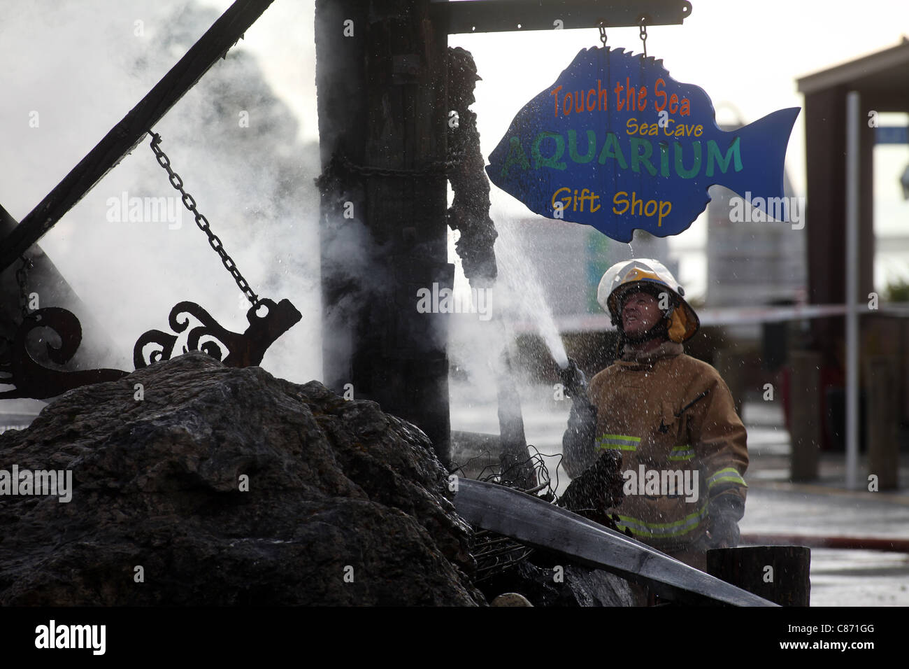 Fire fighter spraying water onto a suspicious fire at Mapua's Touch the ...