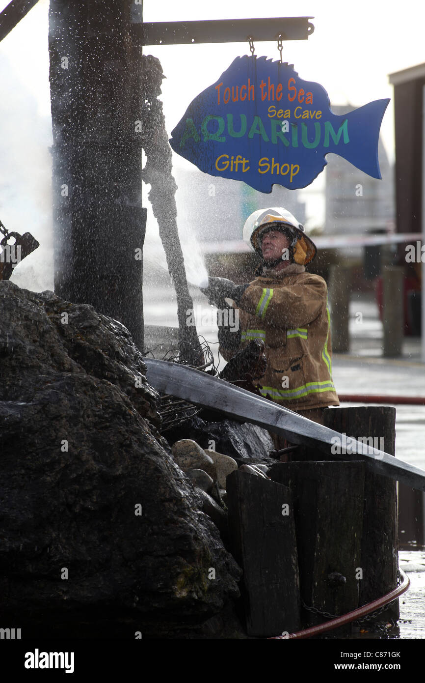 Fire fighter spraying water onto a suspicious fire at Mapua's Touch the ...