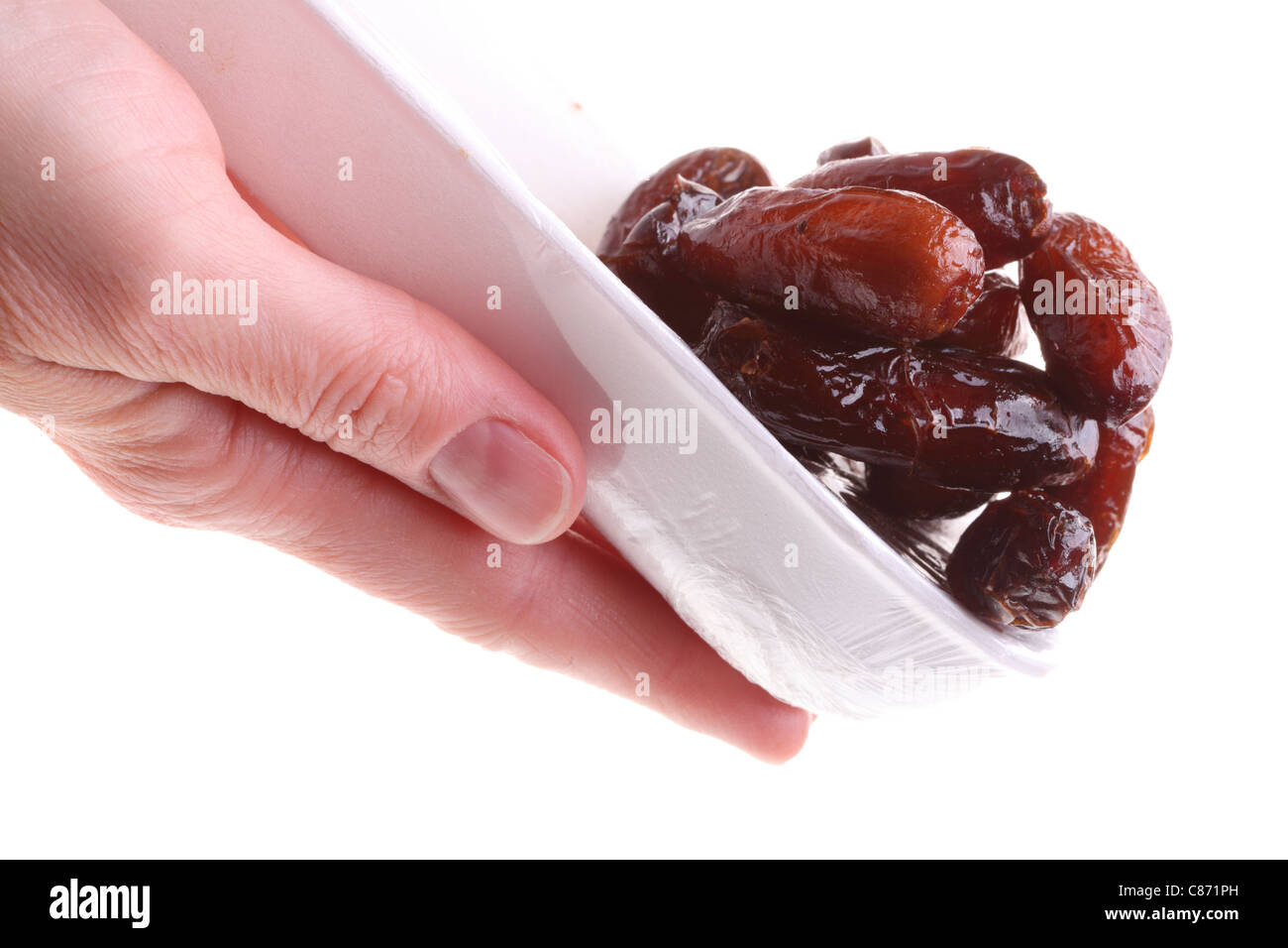Dried date fruits in hand isolated on white background Stock Photo - Alamy