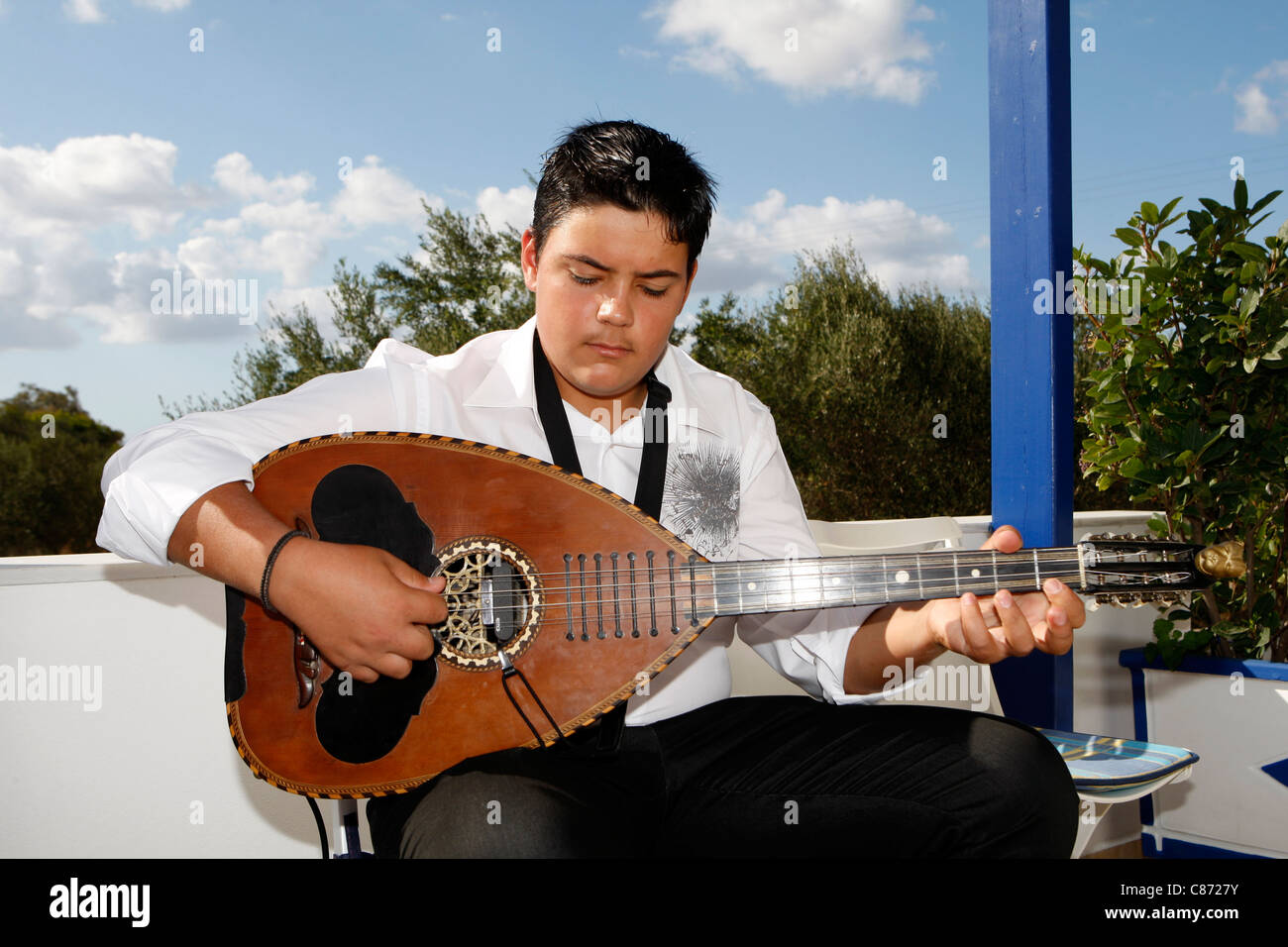 Greek musician play lute in Milos island Stock Photo - Alamy