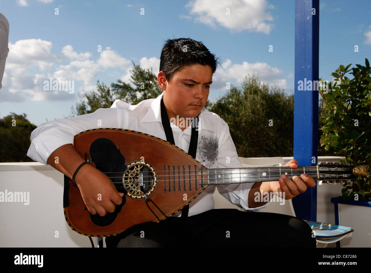 Greek musician play lute in Milos island Stock Photo - Alamy