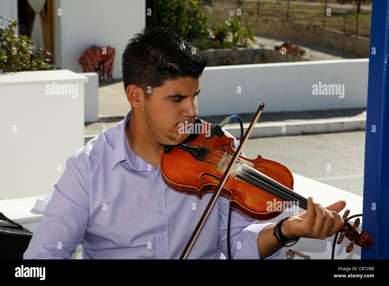 Greek musician in Milos island Stock Photo - Alamy