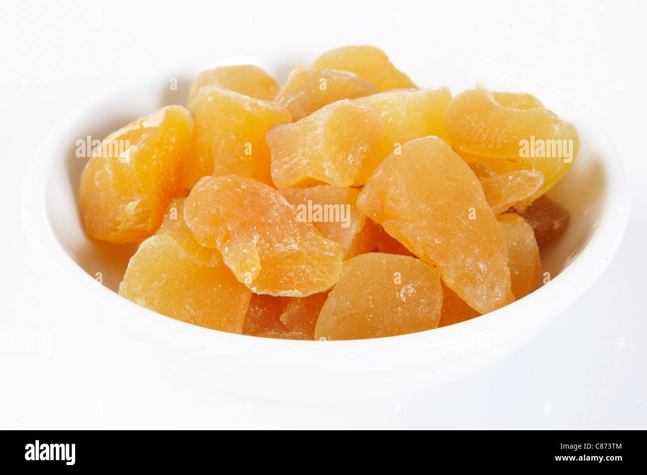 Candied ginger in a white bowl Stock Photo - Alamy