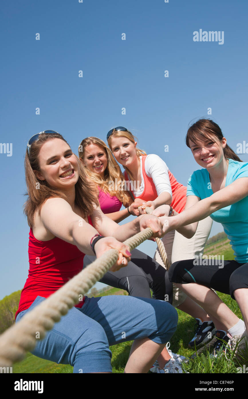Young Women Pulling on Rope Stock Photo - Alamy